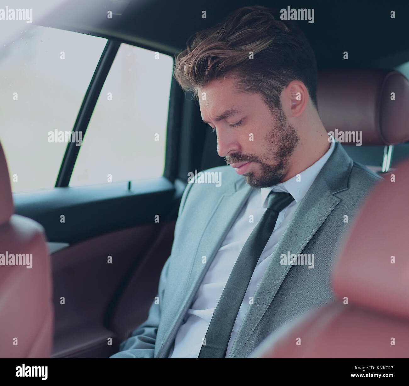 Portrait of an handsome business man in his car Stock Photo - Alamy