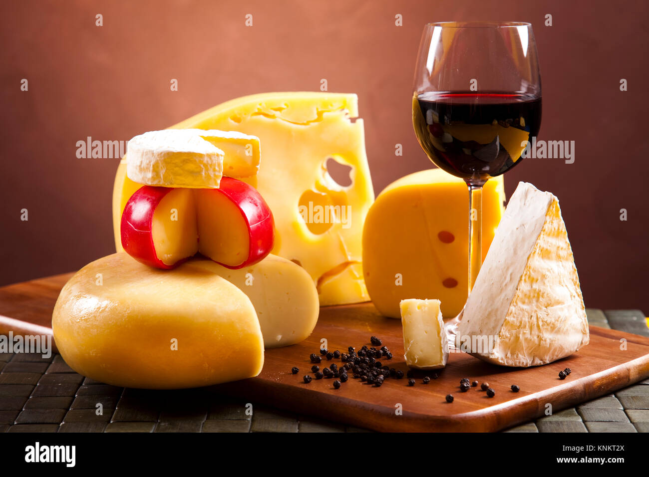 Cheese and red wine, saturated ambient rural theme Stock Photo - Alamy
