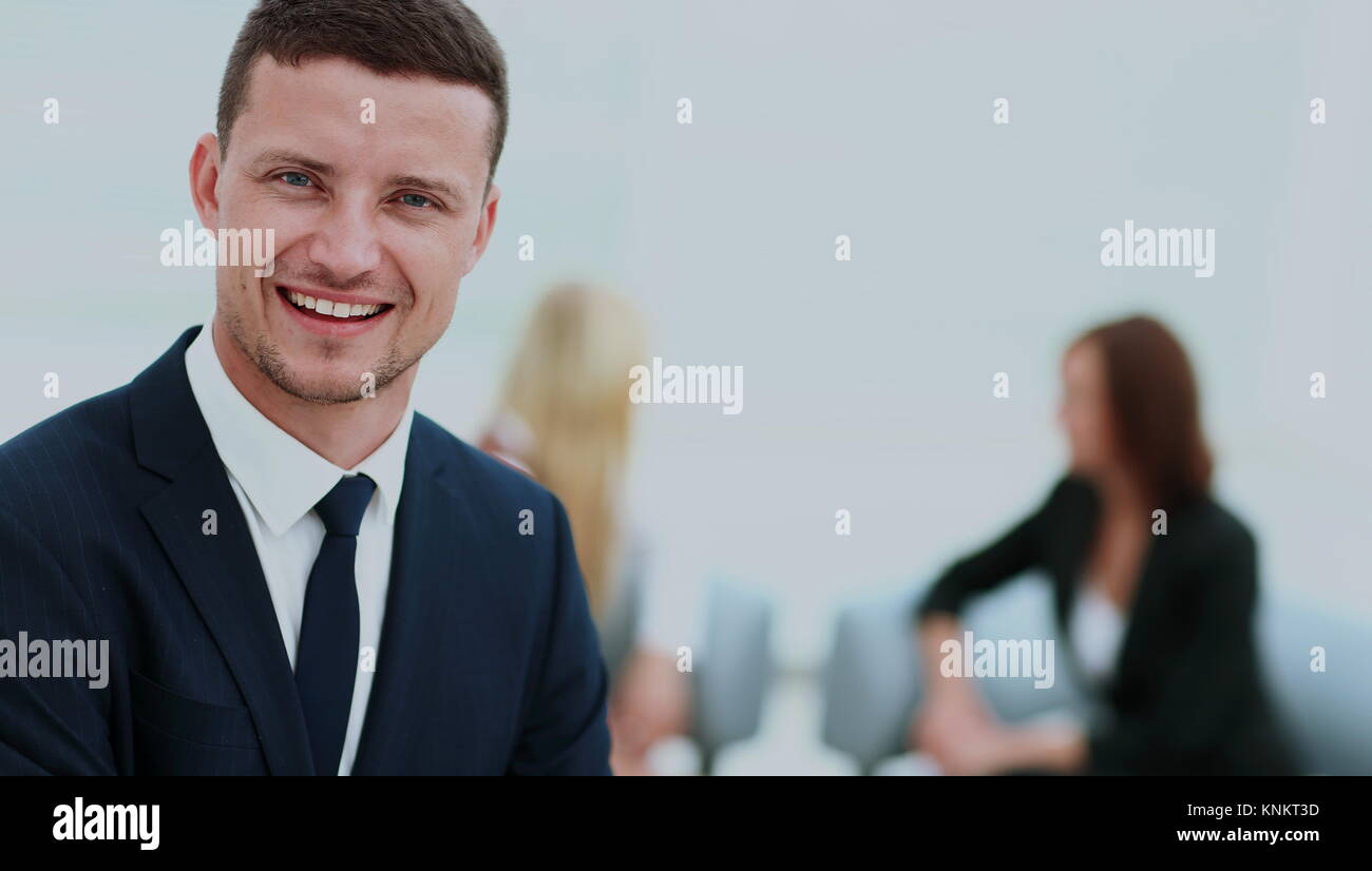 Successful business man standing with his staff in background at Stock ...