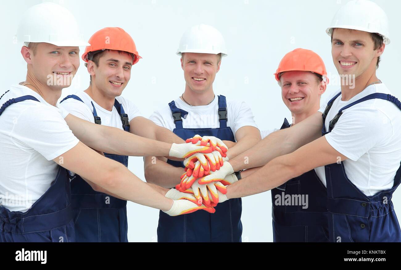 team of builders standing with hands clasped together Stock Photo - Alamy