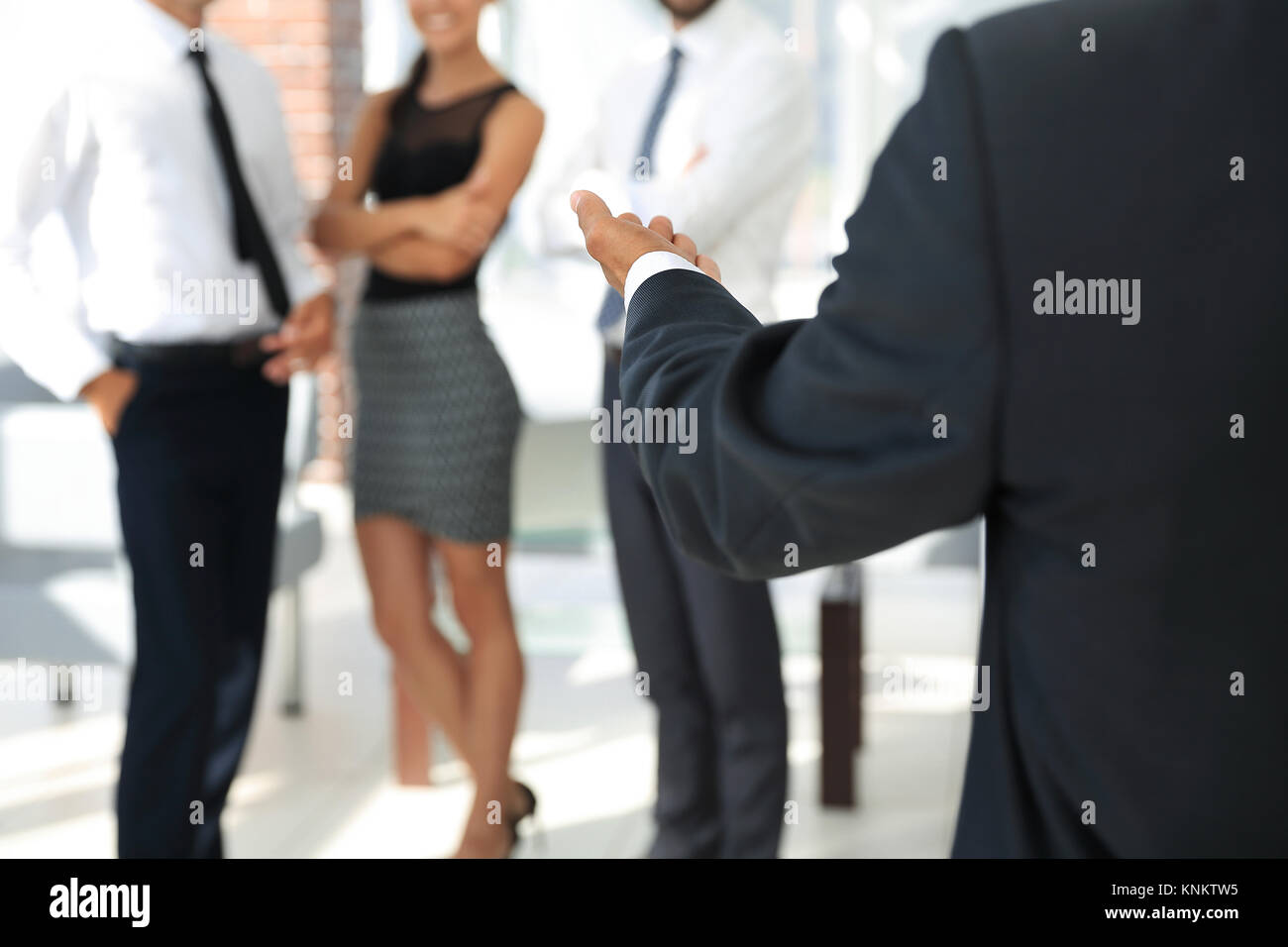 rear view.closeup. businessman holding out hand for a handshake Stock ...