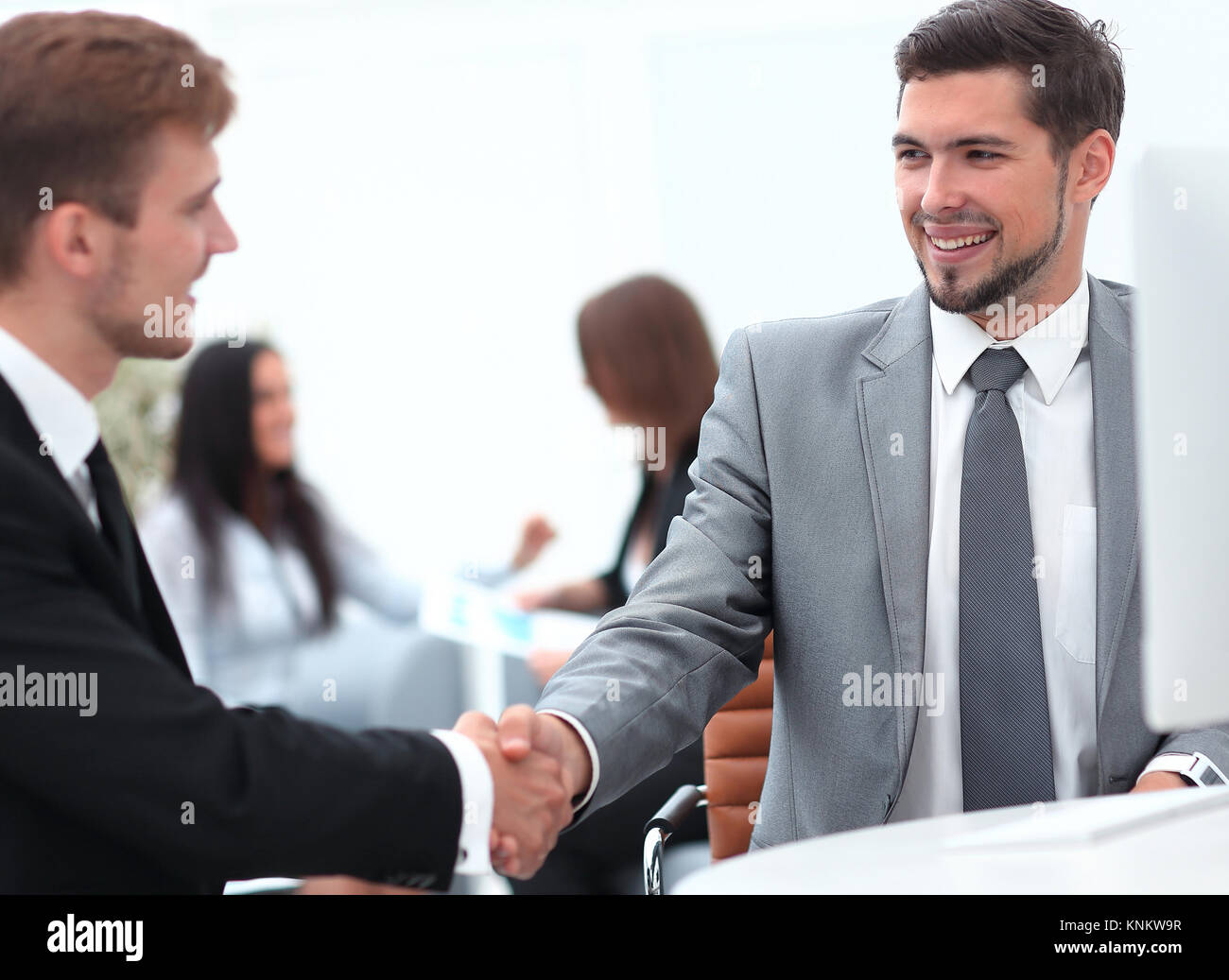 handshake Manager and the client in the office Stock Photo - Alamy