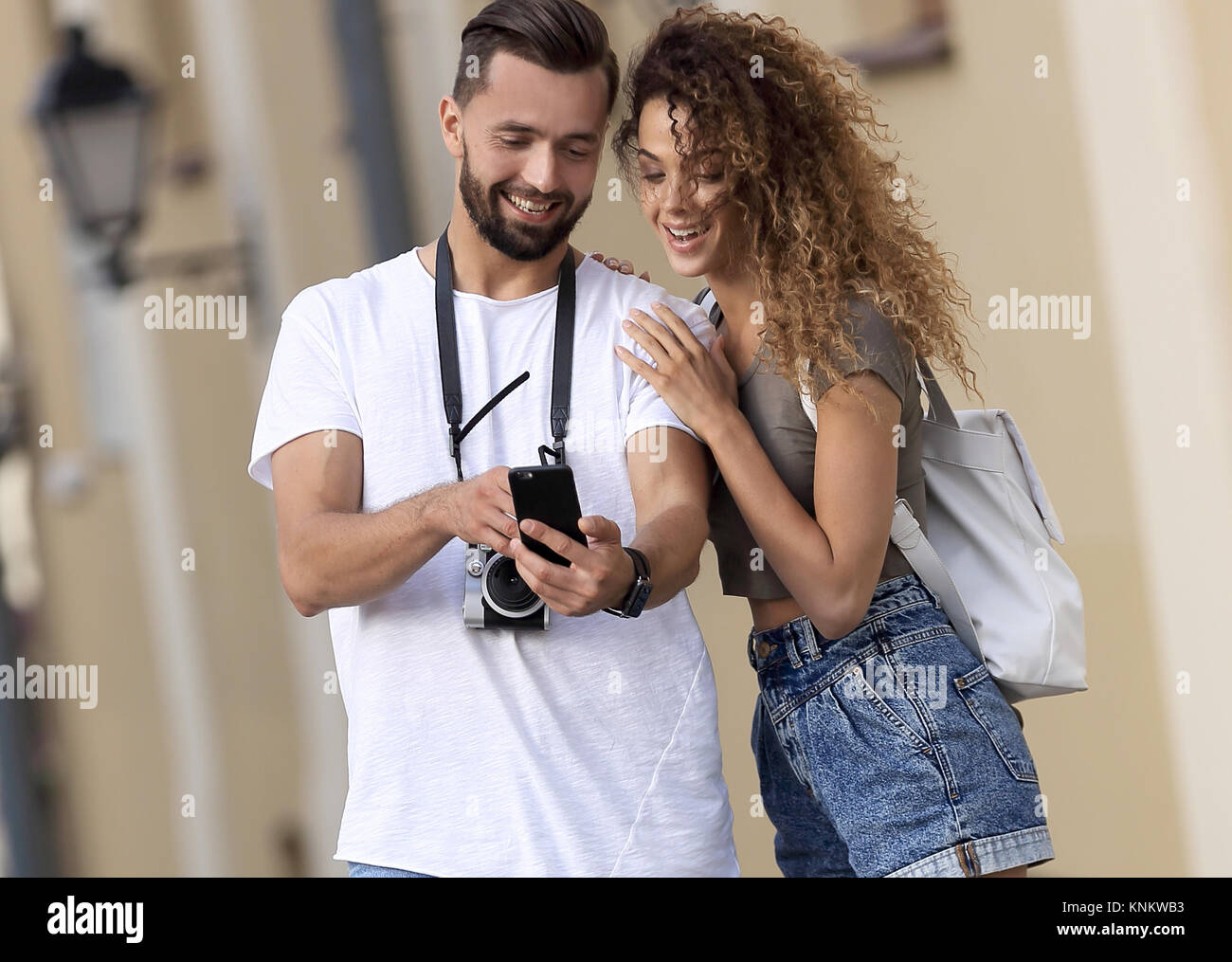 Couple of happy smiling tourists walking around the city Stock Photo ...