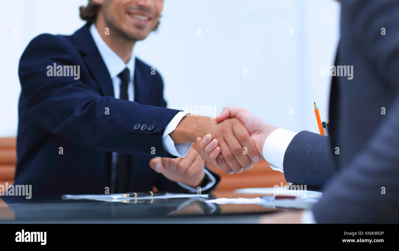 handshake Manager and the client sitting in the office Stock Photo - Alamy