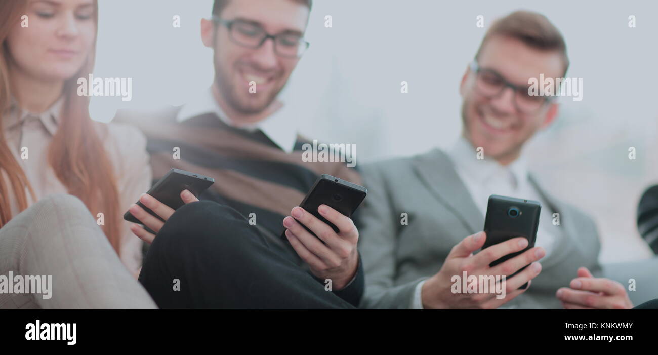 Group of young people use their phones Stock Photo - Alamy