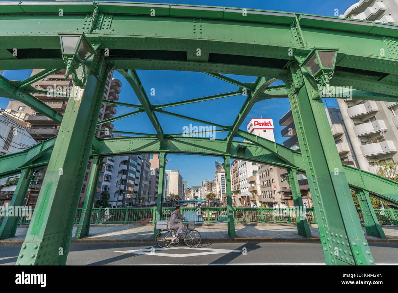 Man riding a bicycle at Yanagi Bridge (Yanagibashi) over Kanda River ...