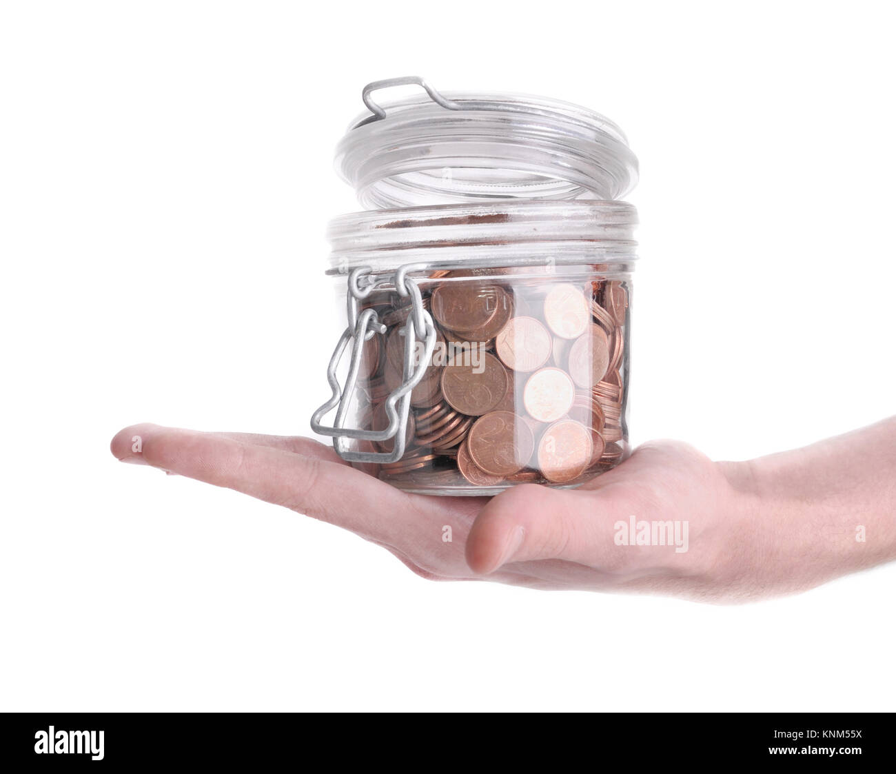coins in a glass jar put on the palm of a hand isolated on white ...