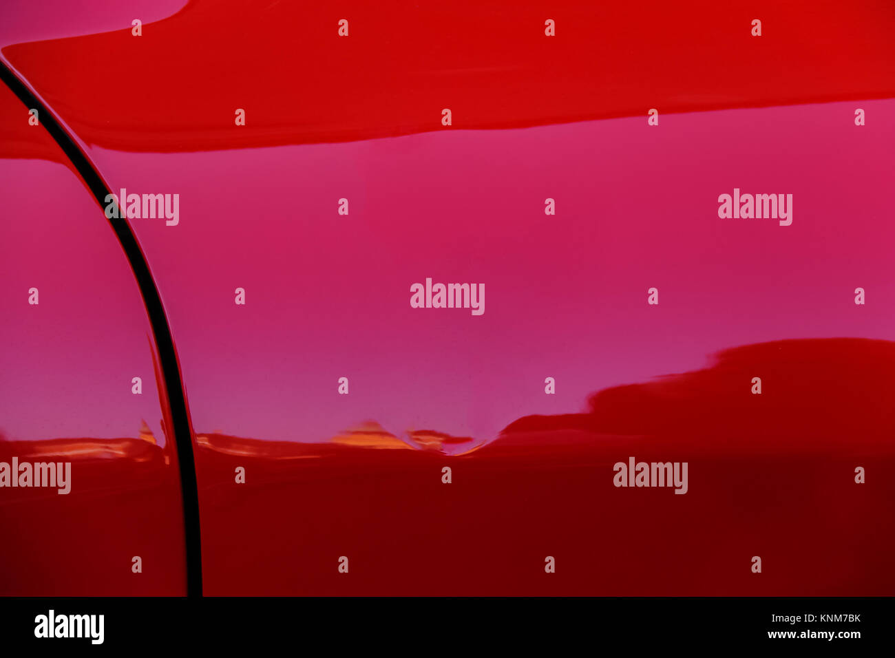 Reflections in side wing of red sport car Stock Photo - Alamy