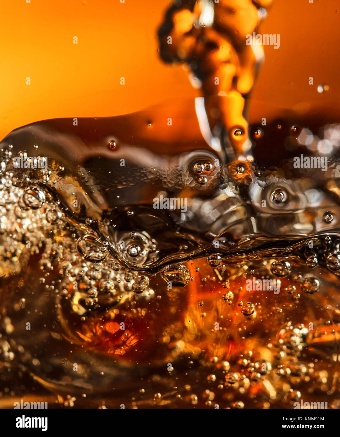 Close-up of a glass with alcohol on a yellow background Stock Photo - Alamy