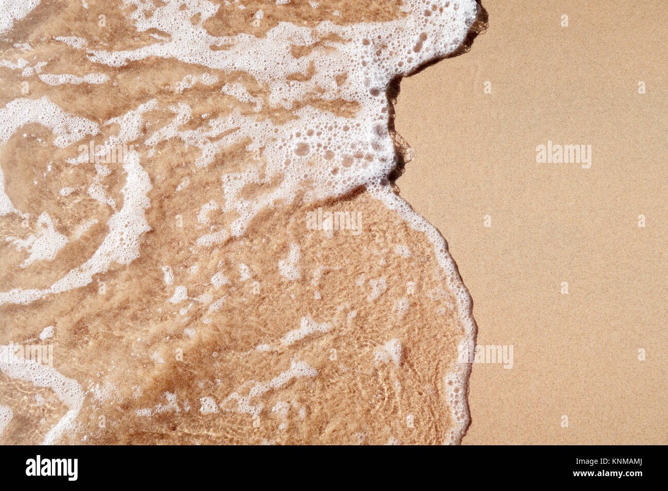 Transparent soft wave on sandy beach Stock Photo - Alamy