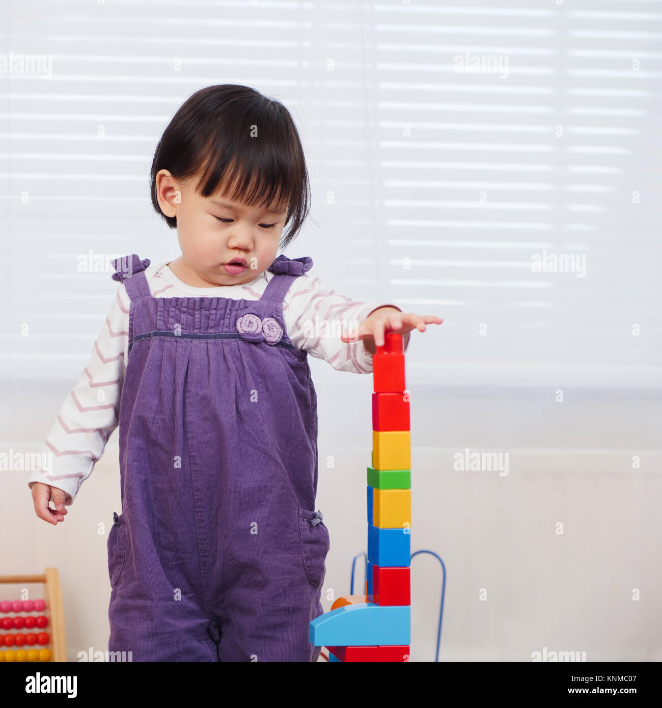 Baby girl play building blocks at home Stock Photo - Alamy