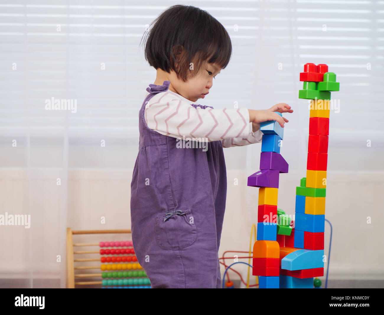 Baby girl play building blocks at home Stock Photo - Alamy