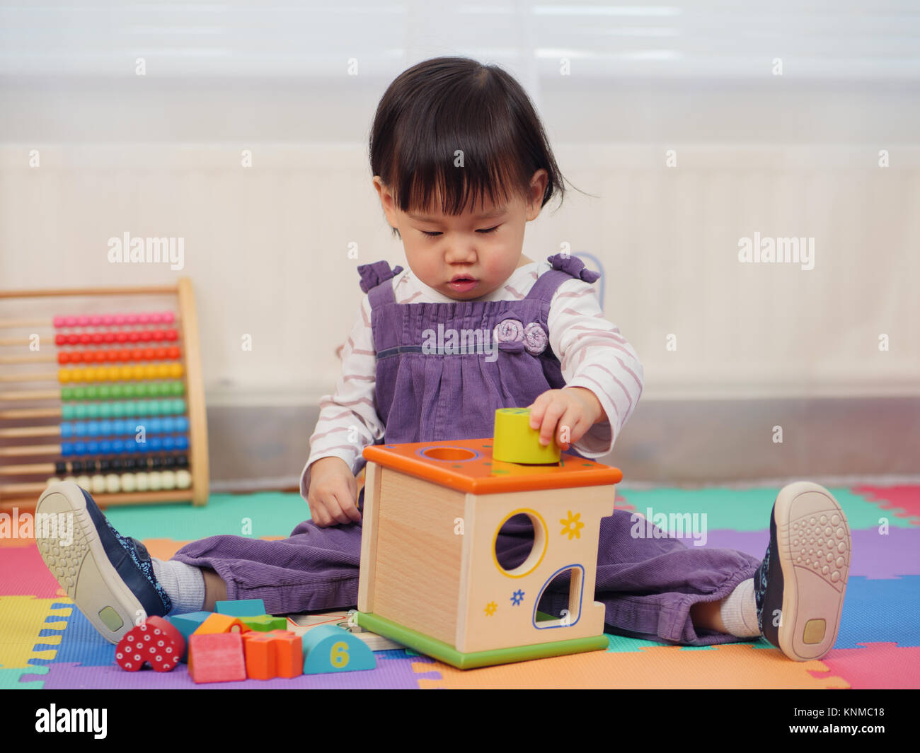 Baby girl play toy at home Stock Photo - Alamy