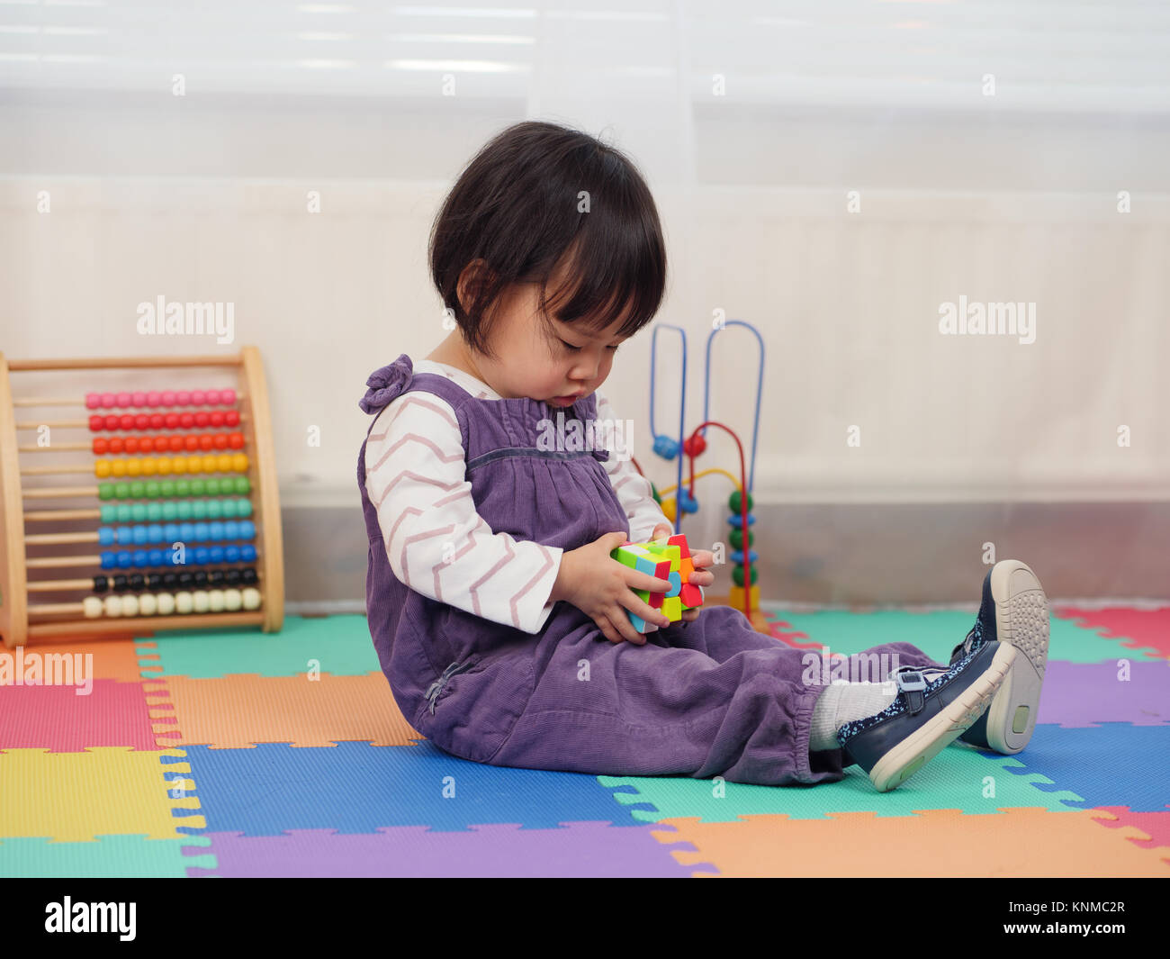 Baby girl play toy at home Stock Photo - Alamy