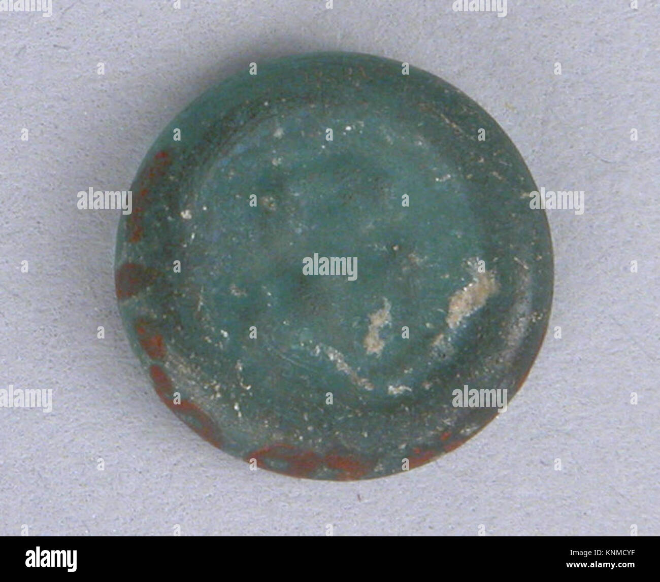 An Egyptian glass coin weight from the 10th-12th century, used ...