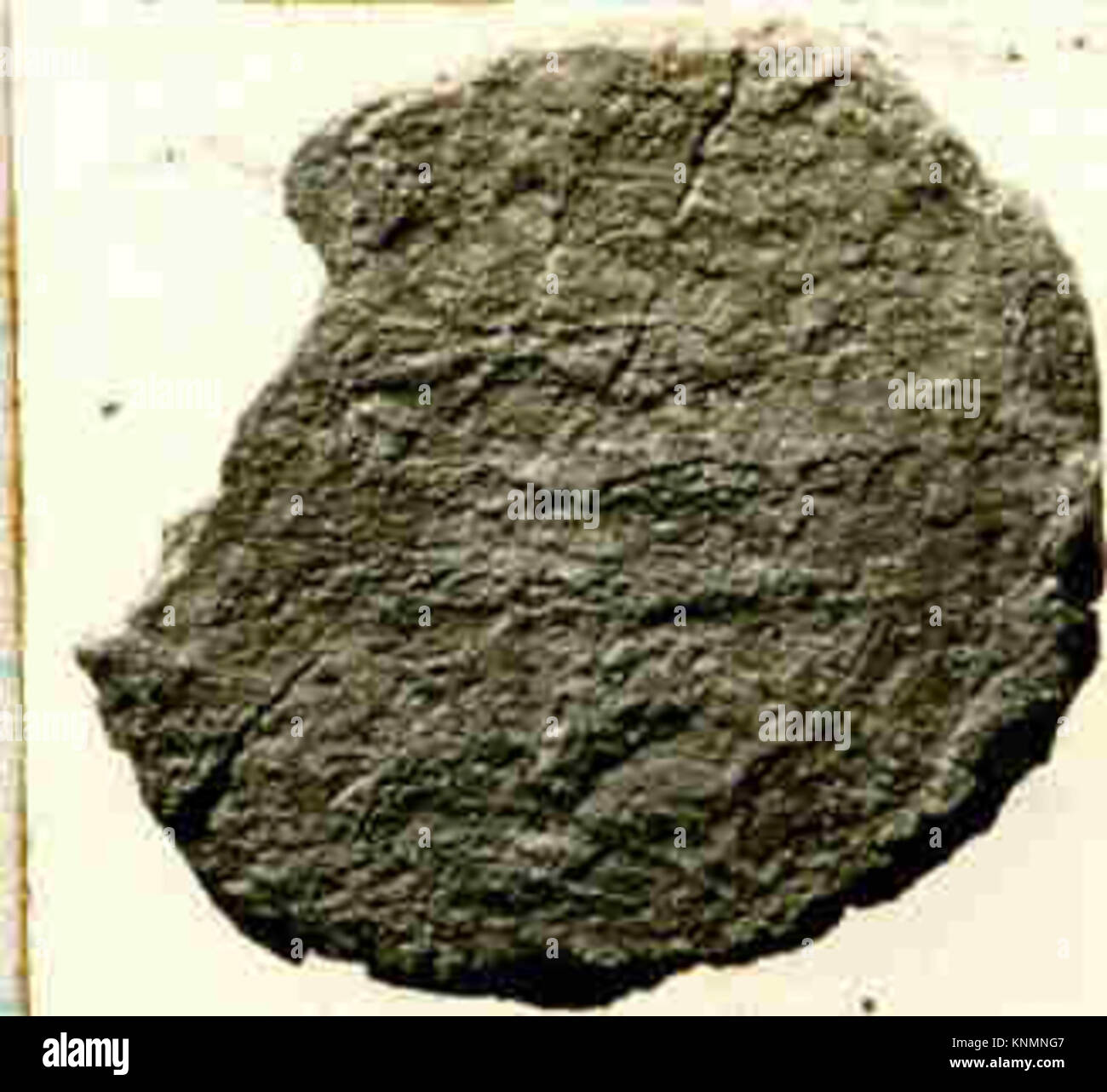 Photograph of an ancient coin with visible markings, used in trade and ...