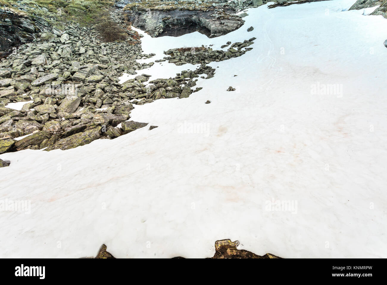 Stone rocks mountain covered in white winter snow. Texture contrast ...