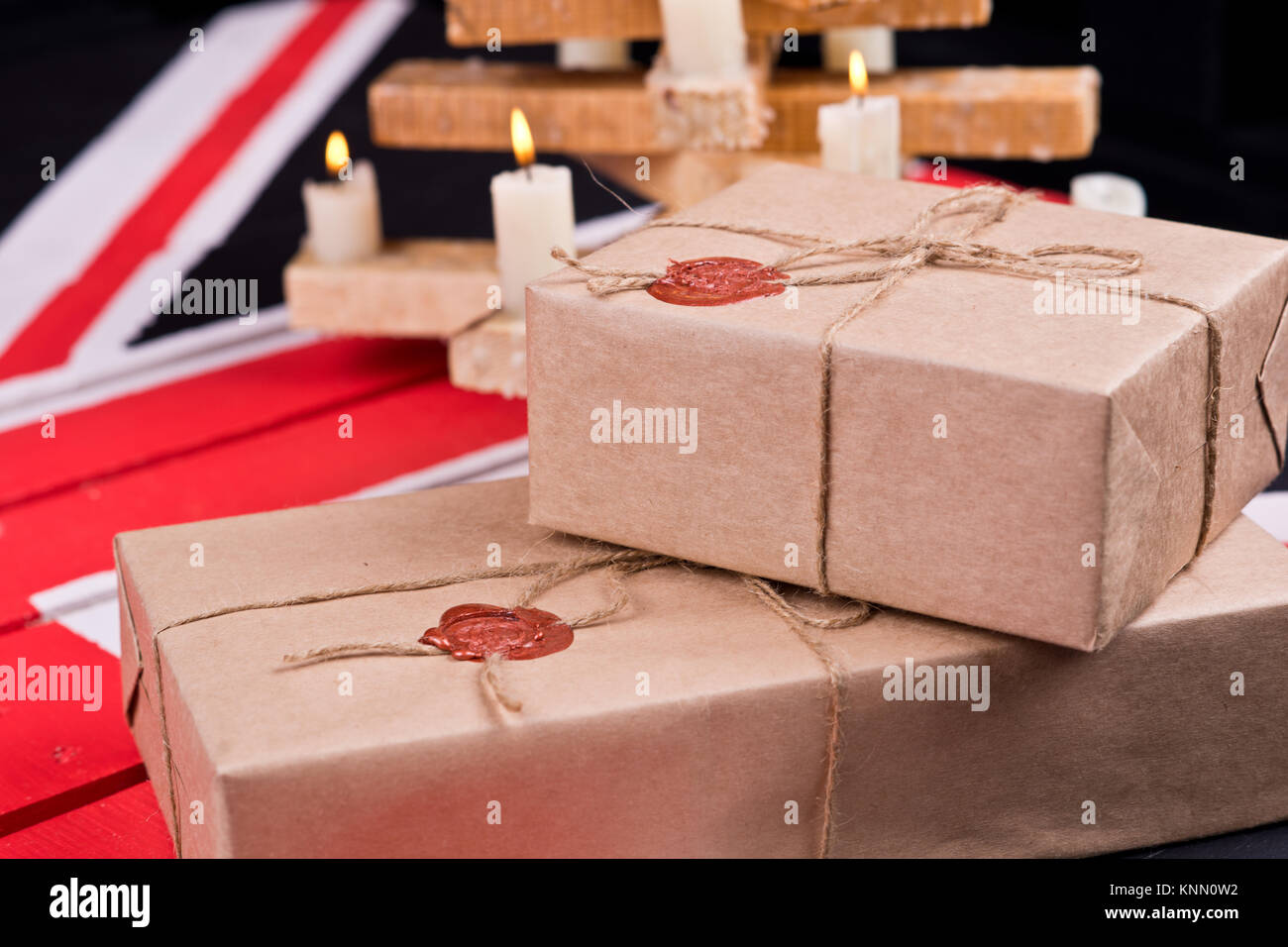 Boxes, wrapped into craft paper, fixed with packthread with a wafer on ...