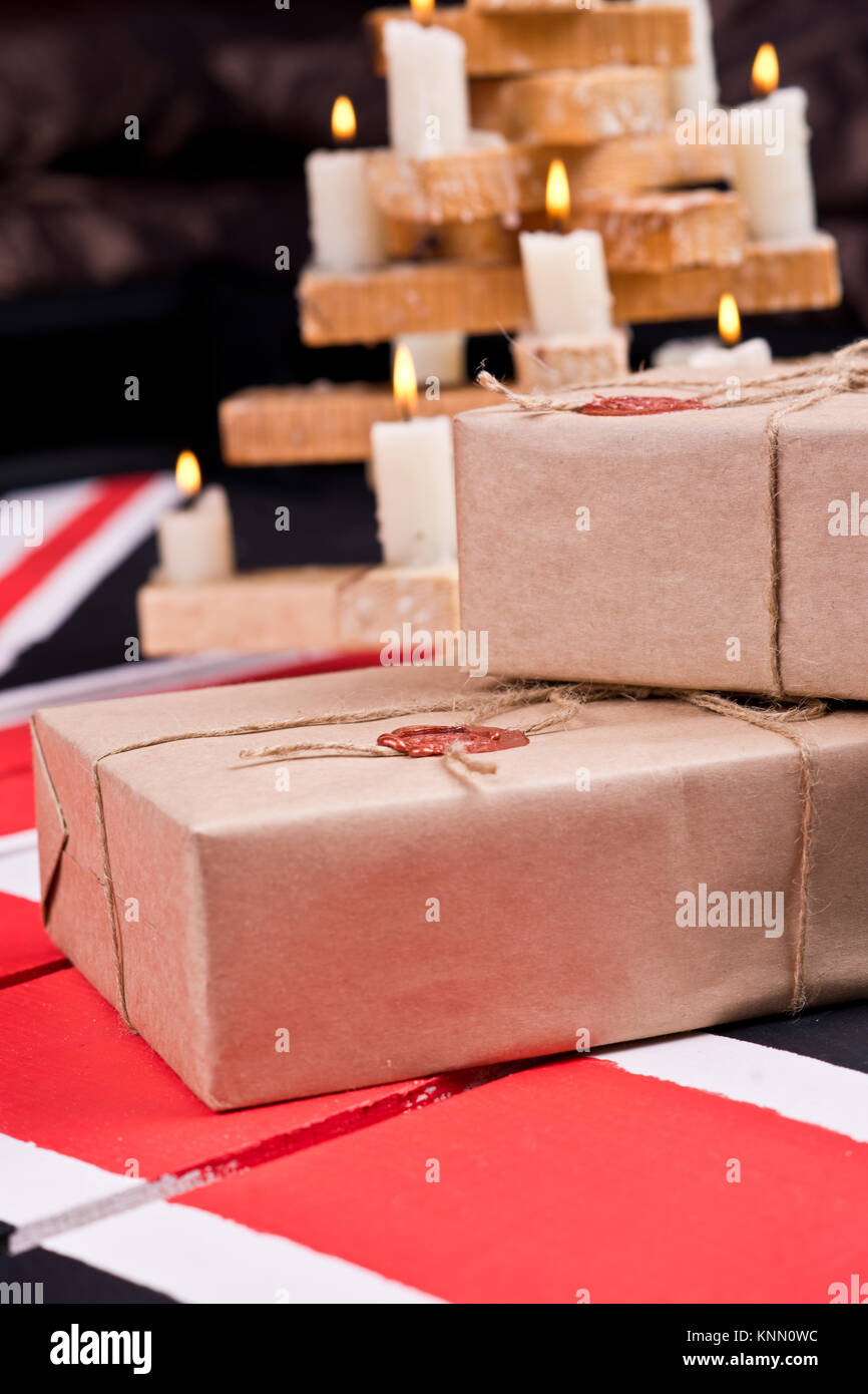 Boxes, wrapped into craft paper, fixed with packthread with a wafer on ...