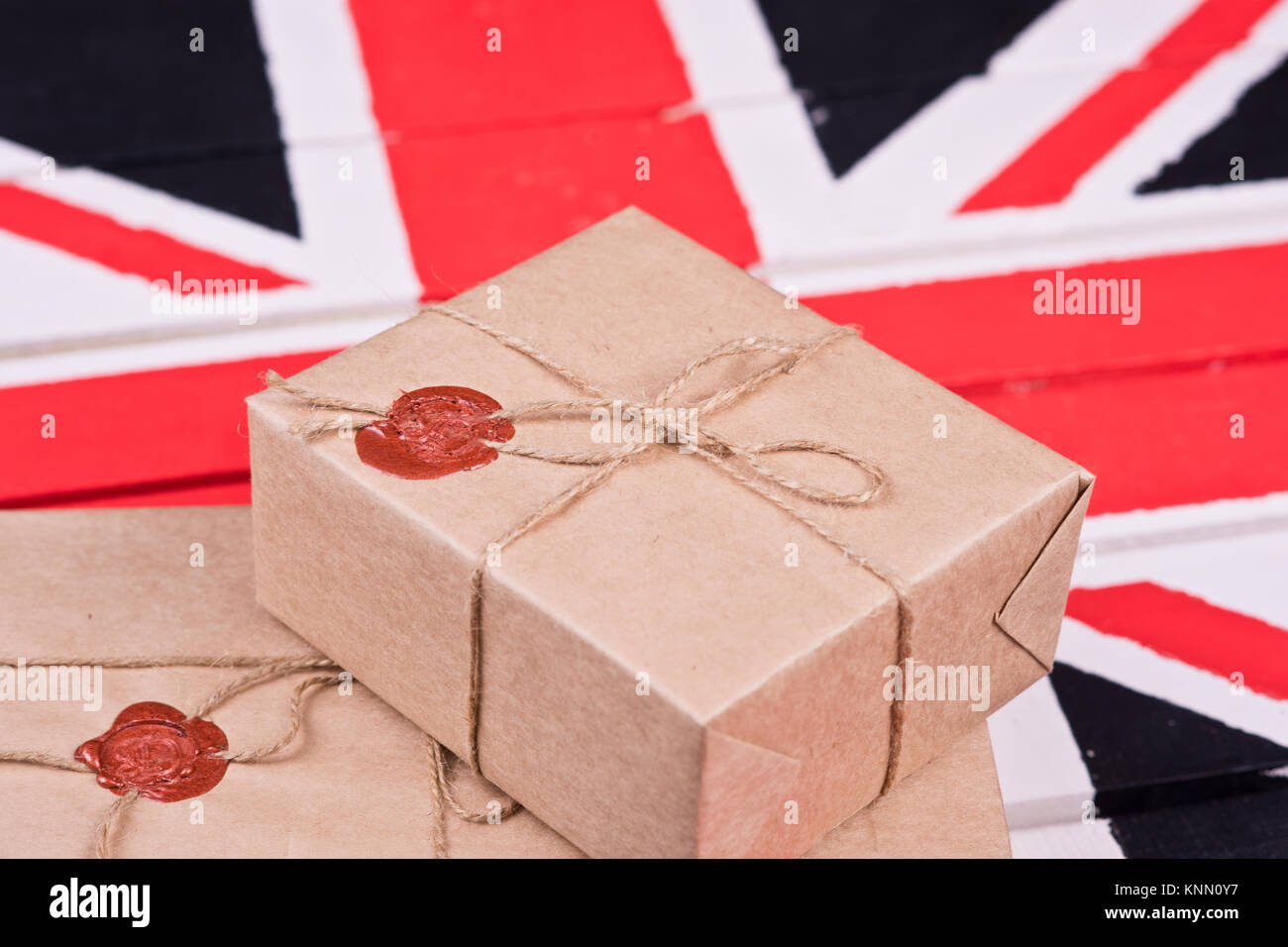Boxes, wrapped into craft paper, fixed with packthread with a wafer on ...