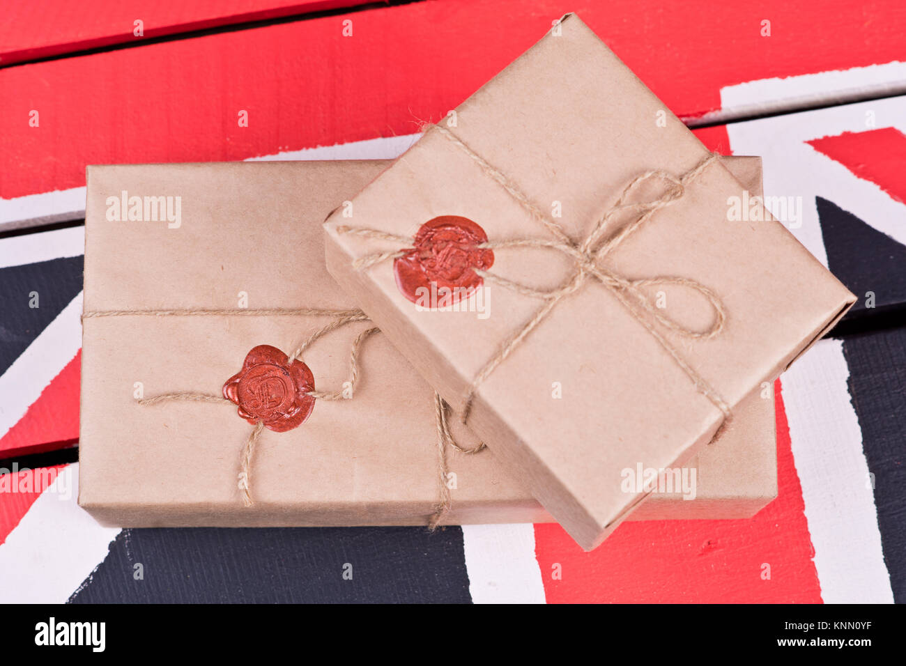 Boxes, wrapped into craft paper, fixed with packthread with a wafer on ...