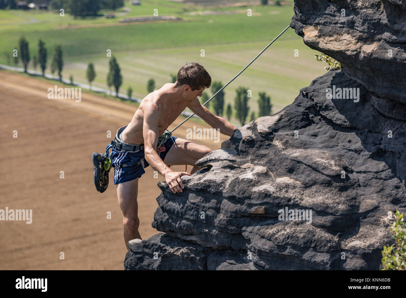 Lilienstein, Germany - August 14, 2017. A young climber with a muscular ...