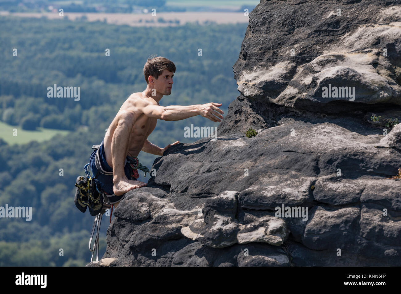Lilienstein, Germany - August 14, 2017. A young climber with a muscular ...