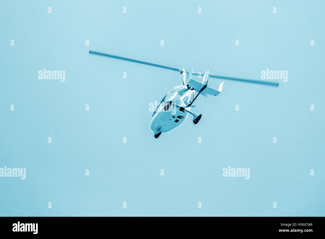 Small white gyroplane flying on blue sky, Ultralight gyroplane Stock ...