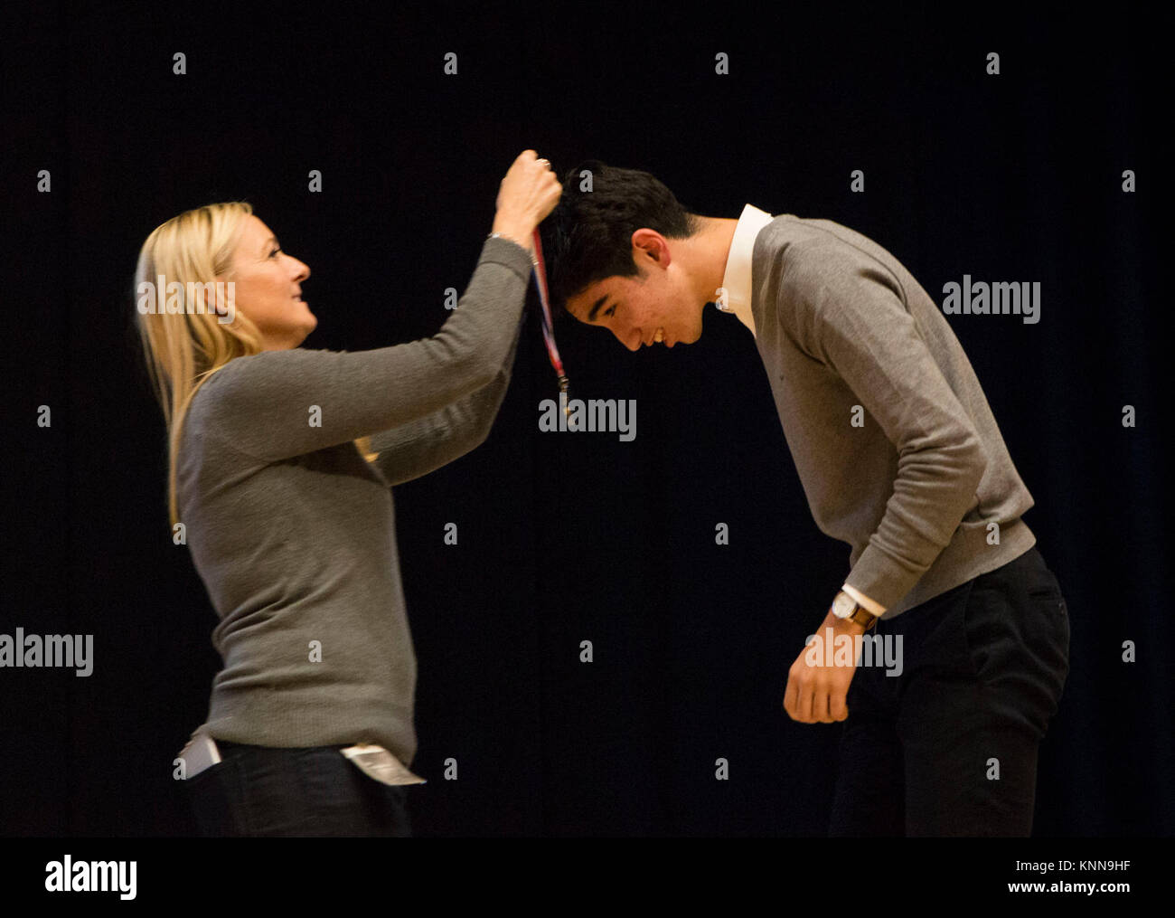 Renee Burke, left, a yearbook specialist, awards Shohtaro Carroll, a ...