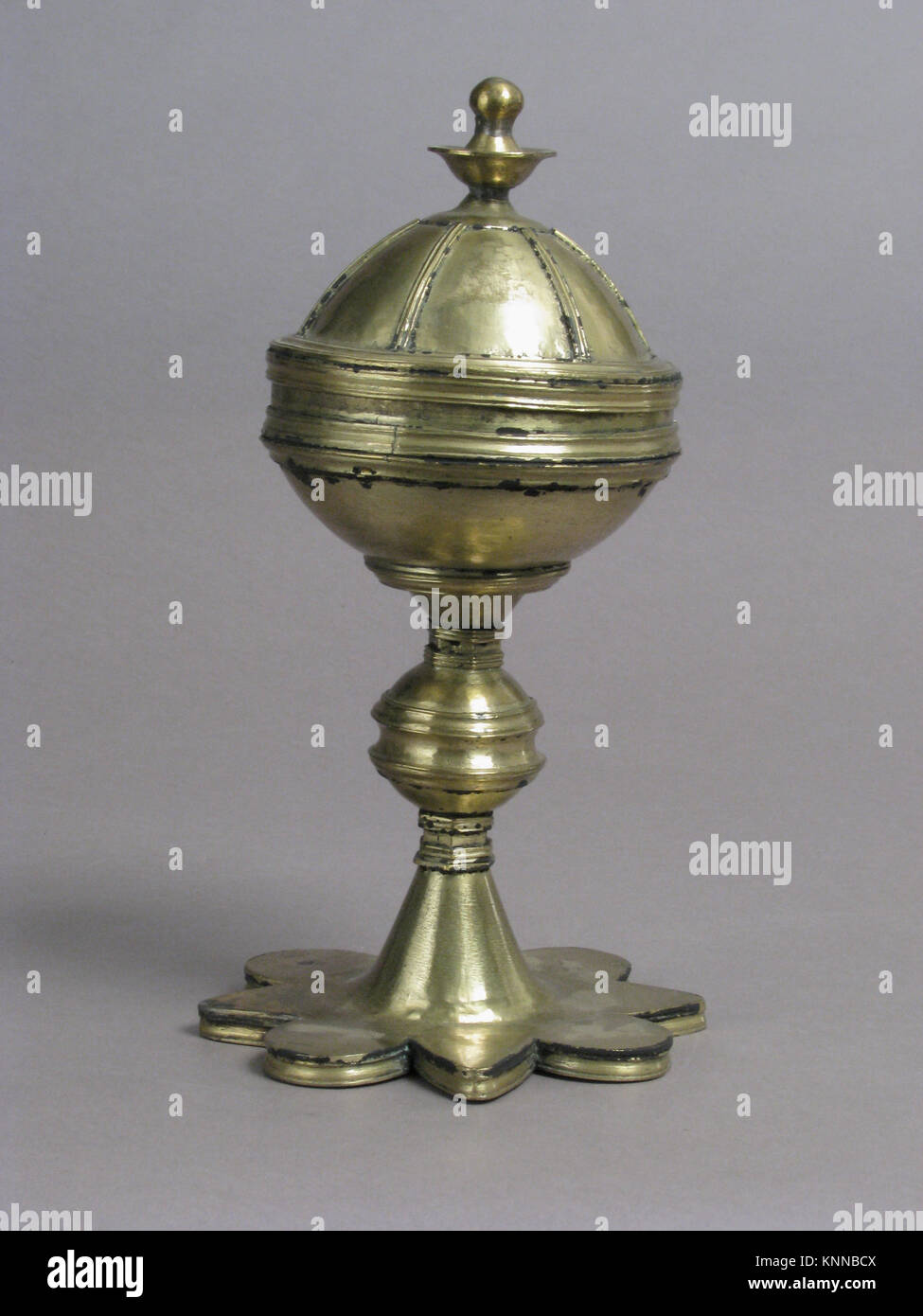 Metal liturgical ciborium with domed cover and base, used to store the ...