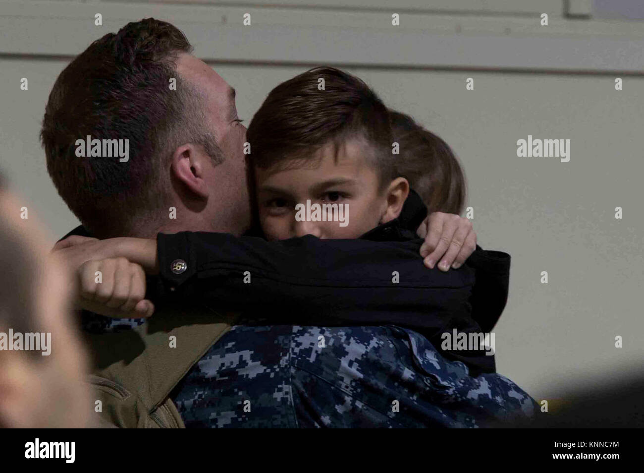 A U.S. Navy Sailor hugs his son at Marine Corps Air Station Iwakuni ...