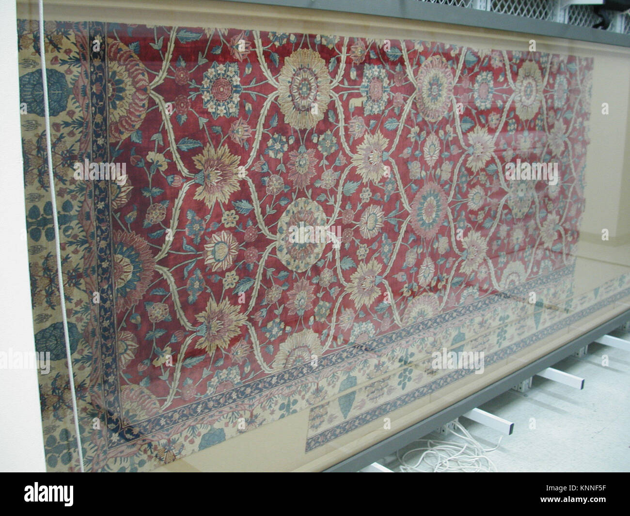 Fragments of a carpet with lattice and blossom pattern, showing textile ...