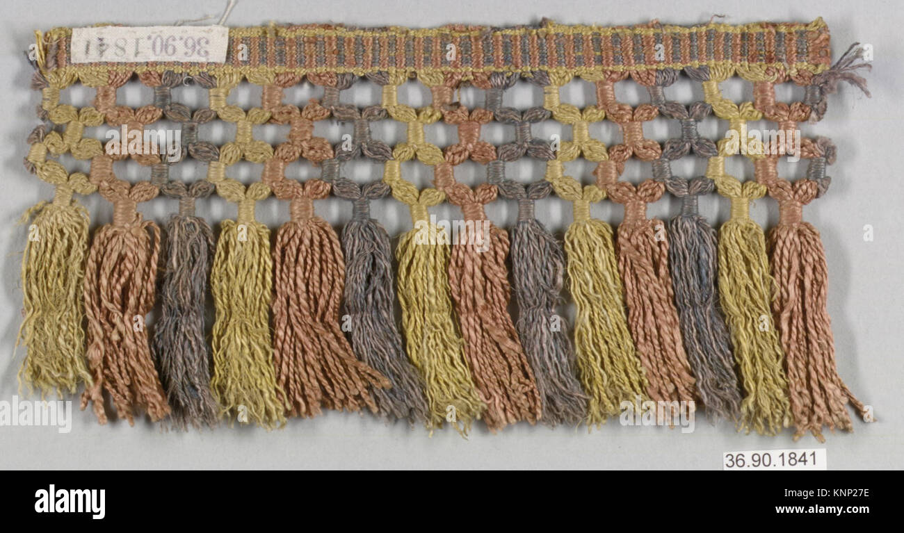 A preserved textile fringe displaying decorative stitching, fabric ...