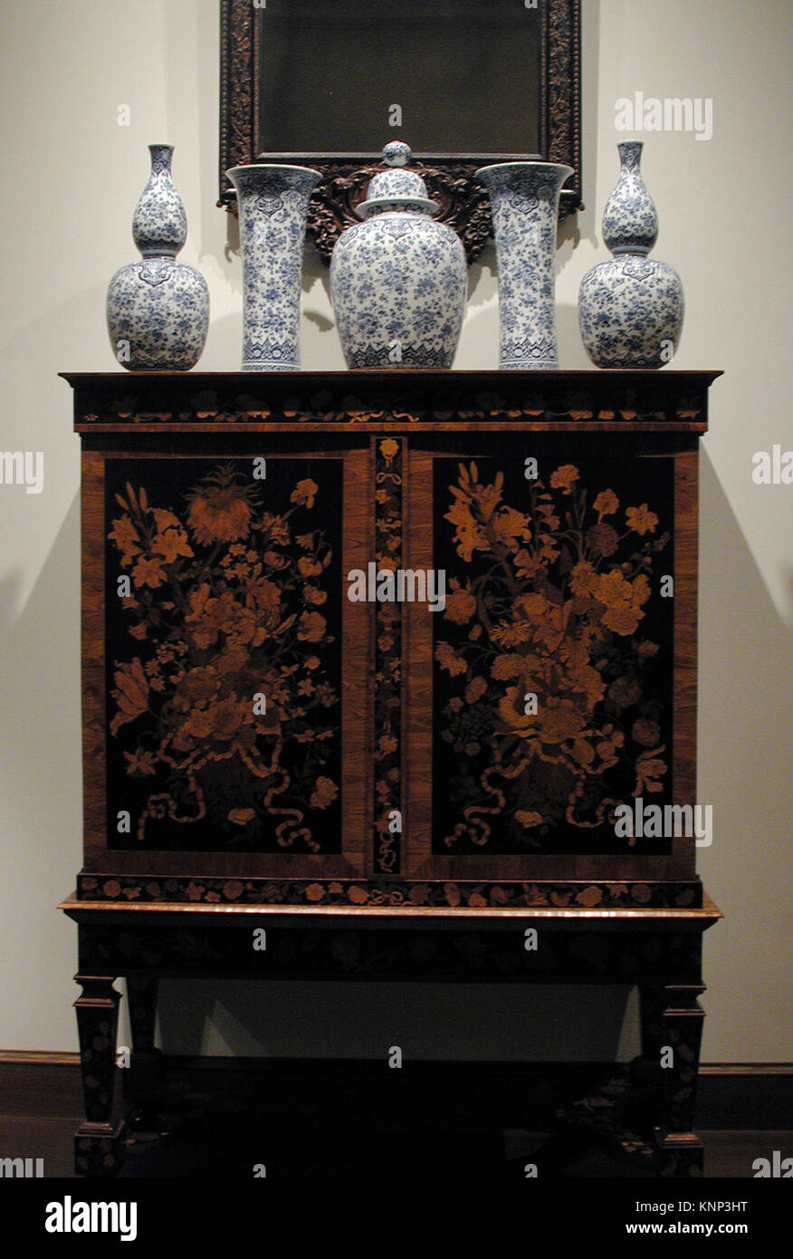 A beaker-shaped vase, part of a matching pair in a garniture set, used ...