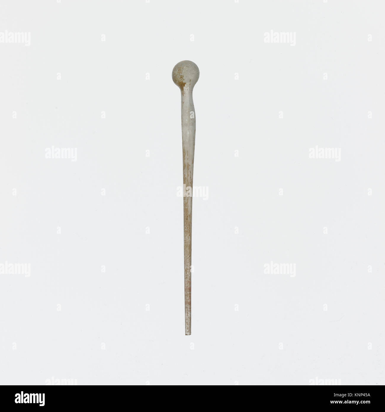 This MET glass pin is a small accessory made from glass, demonstrating ...