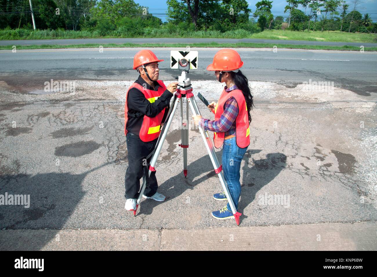 Surveyor Engineer and partner setting measure prism reflector on the ...