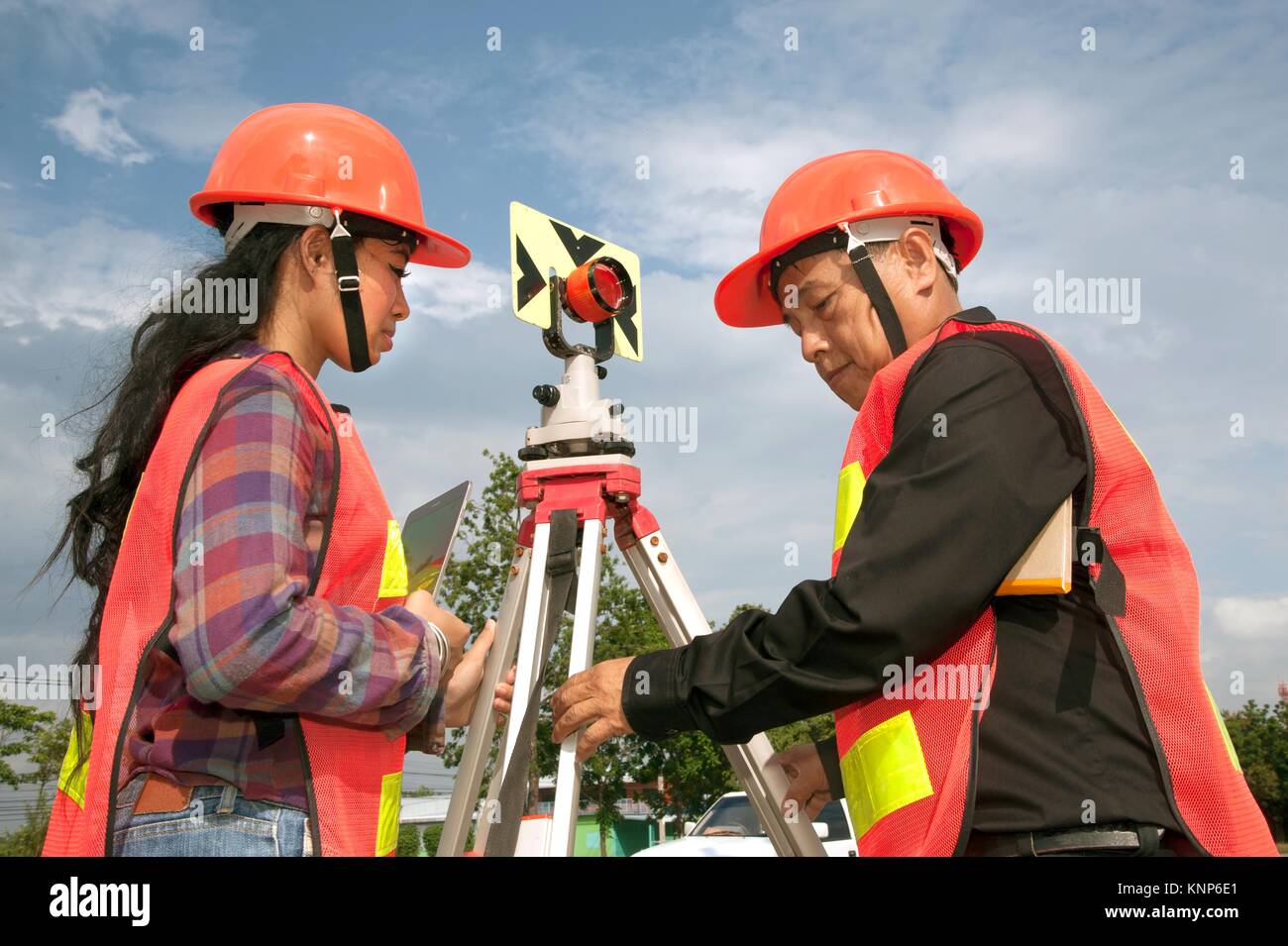 Surveyor Engineer and partner setting measure prism reflector on the ...