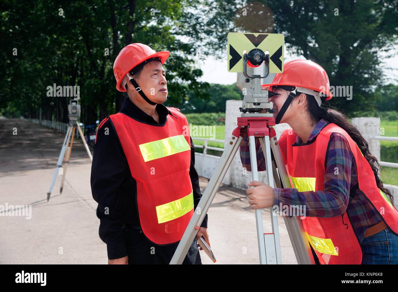 Surveyor Engineer and partner setting measure prism reflector on the ...