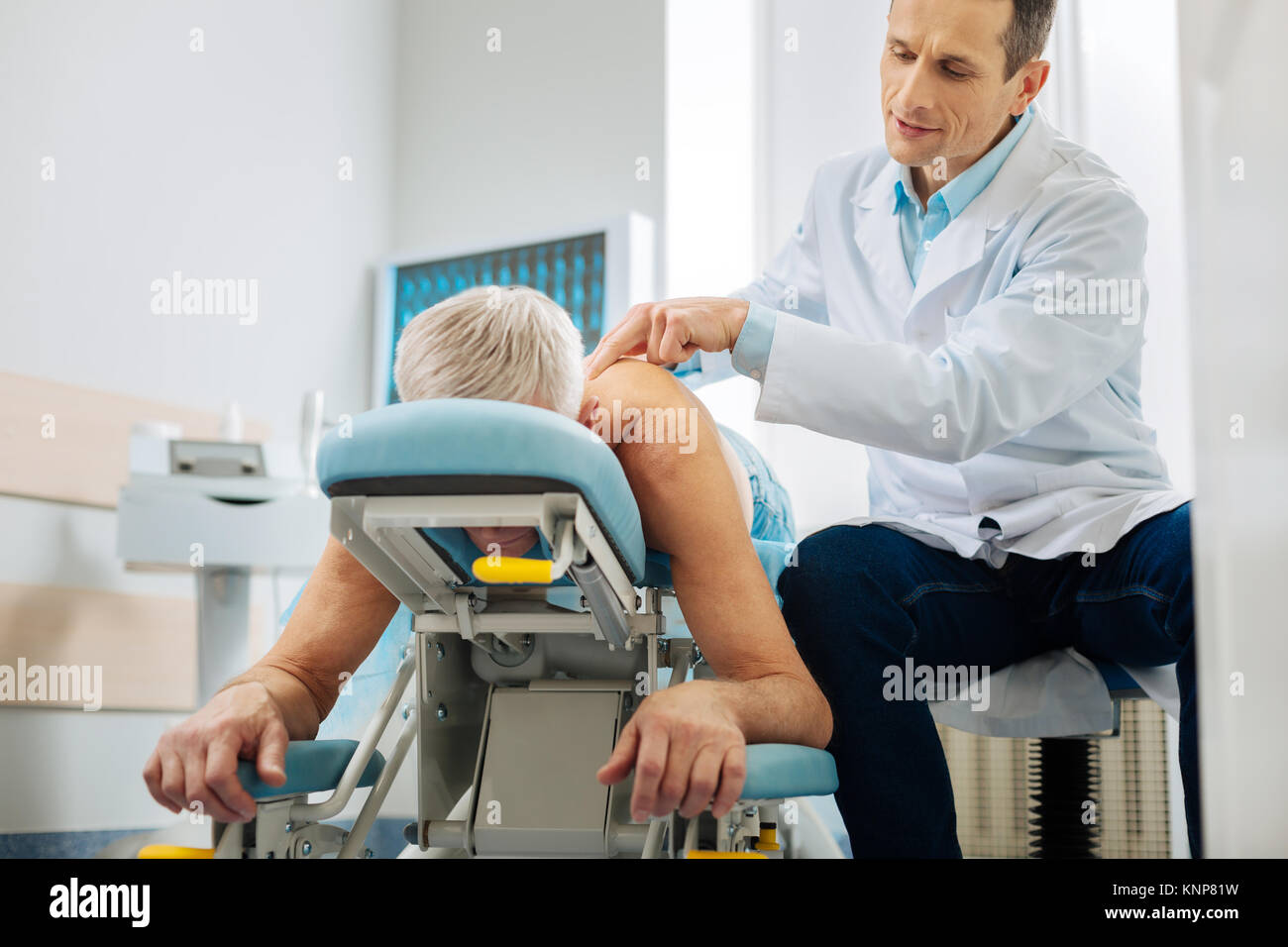 Professional male doctor treating his patient Stock Photo - Alamy
