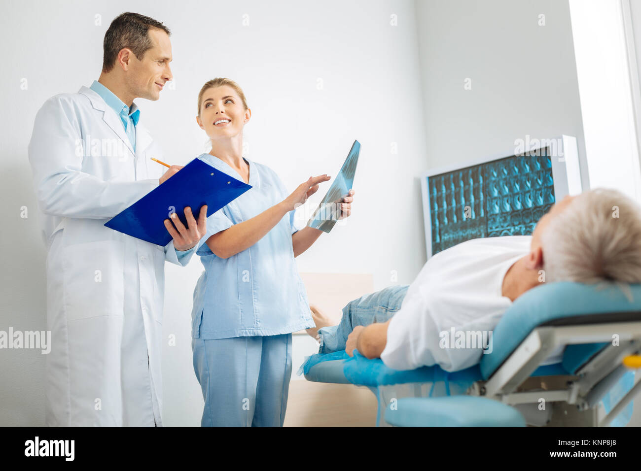 Happy positive doctors talking Stock Photo - Alamy