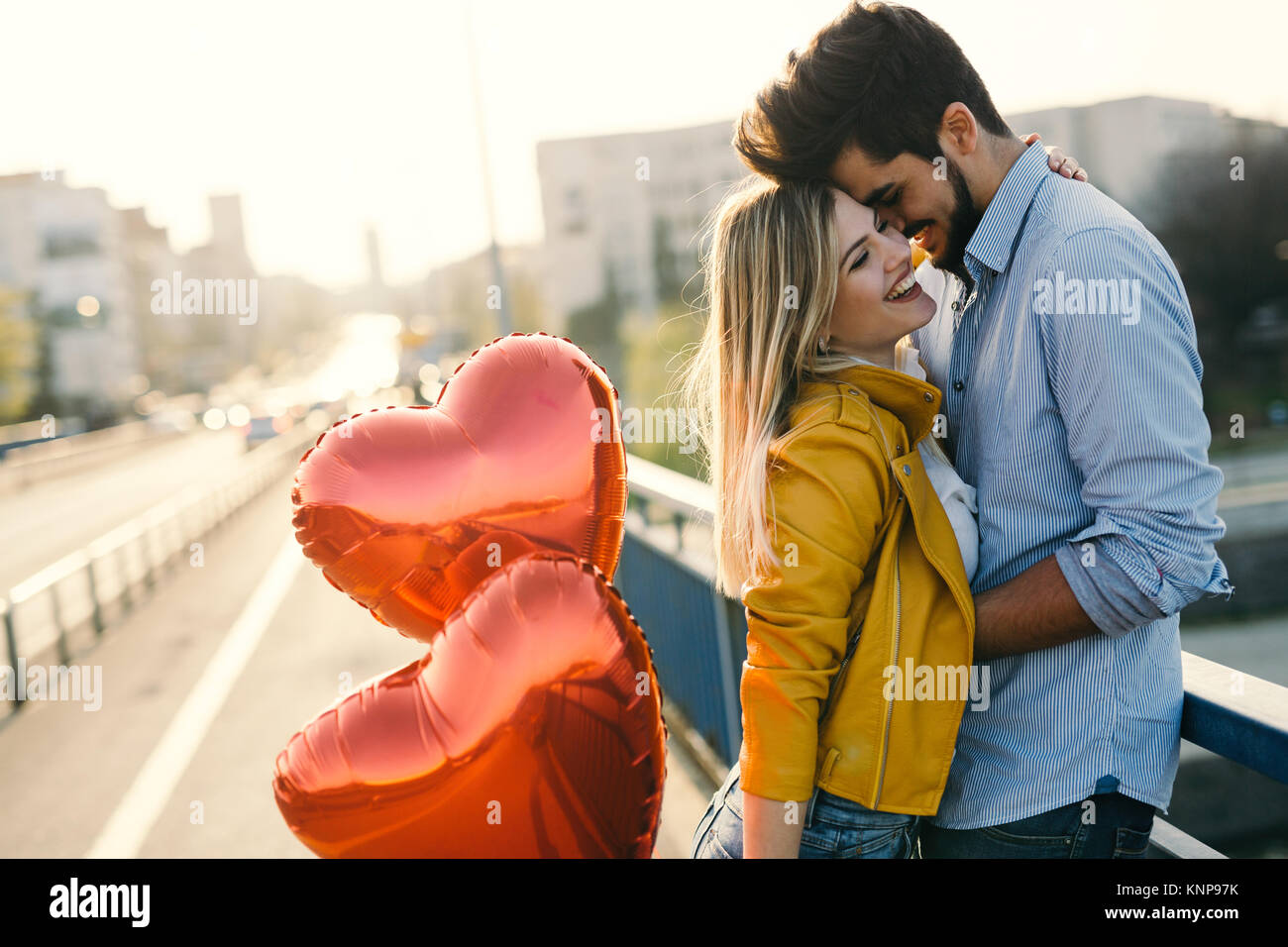 Portrait of loving couple dating at sunset in city Stock Photo - Alamy