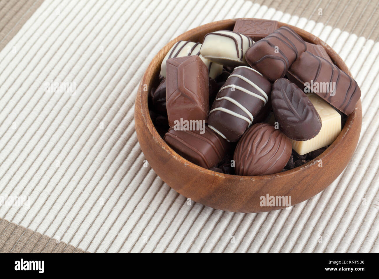 assorted chocolate in wooden bowl Stock Photo - Alamy