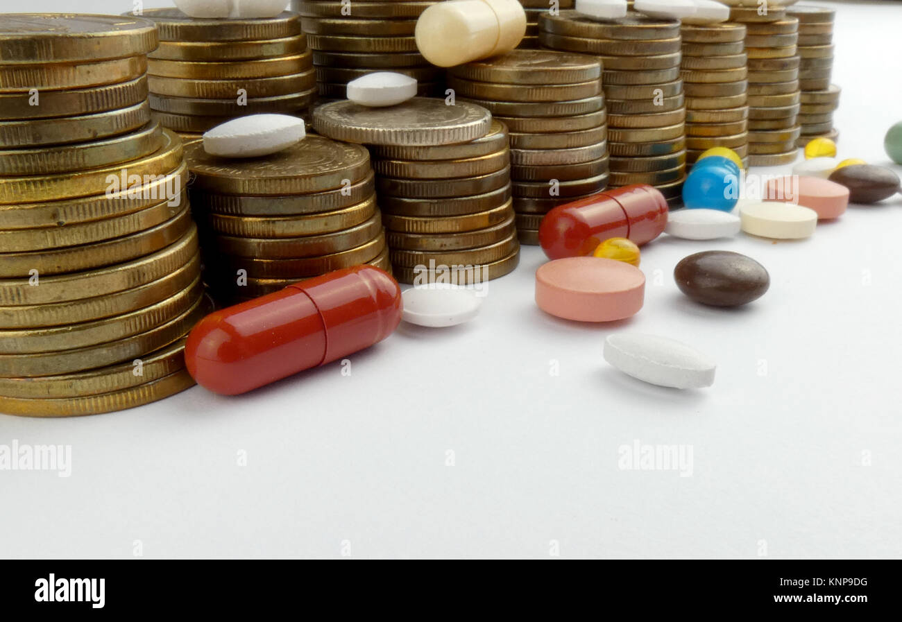 Pills and coins isolated on white background Stock Photo - Alamy