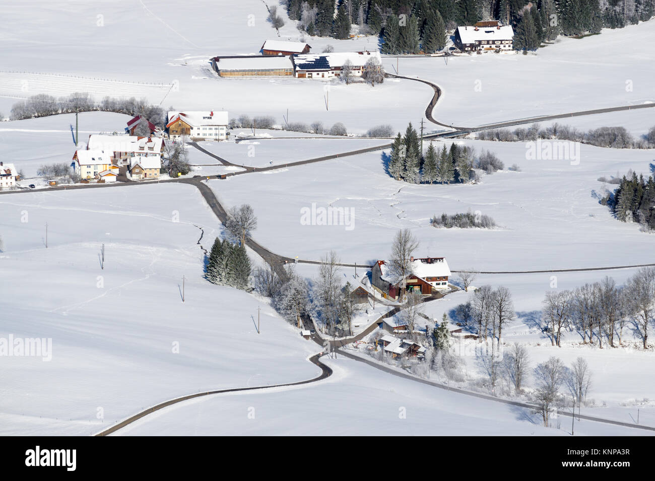 Lovely rural countryside on snowy winter day. Aerial view of barnyards ...