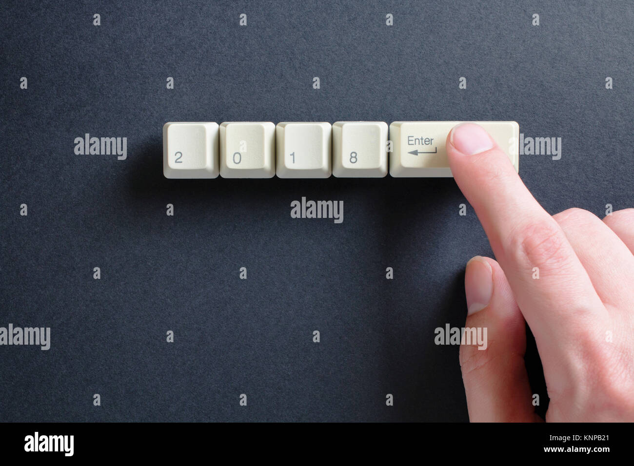 index finger of a man's hand presses on the keyboard, on which is ...