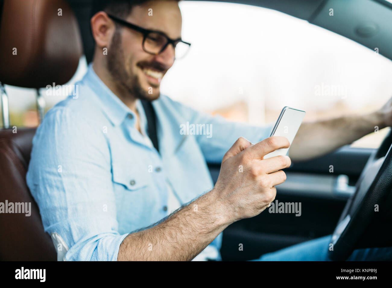 man using phone while driving the car Stock Photo - Alamy
