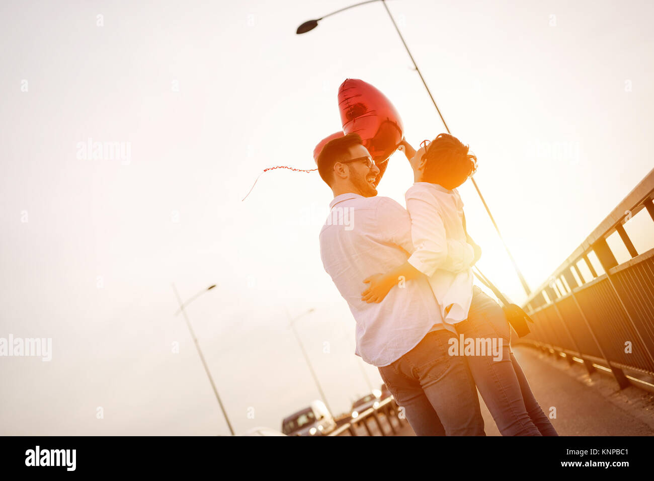 Beautiful couple in love at sunset hugging and dating Stock Photo - Alamy
