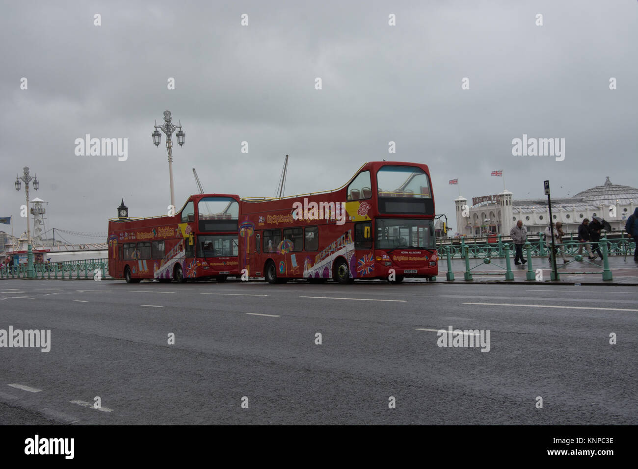 Open top buses wait for customers on a wet and windy day in Brighton ...