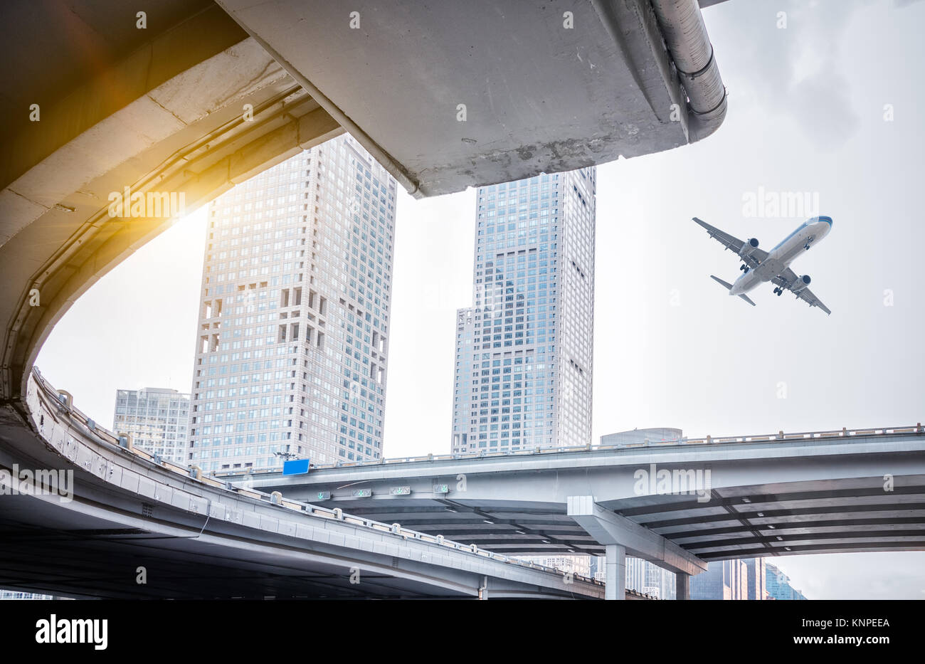 blurred street scene in city with a plane flying over in city of China ...