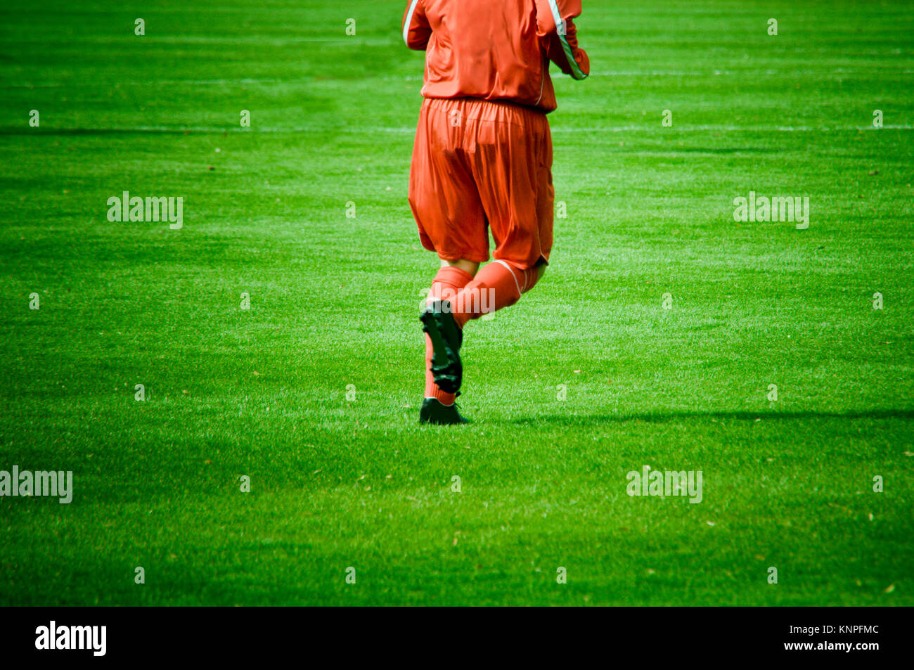 legs of a soccer player in red dress, in action during a game Stock ...